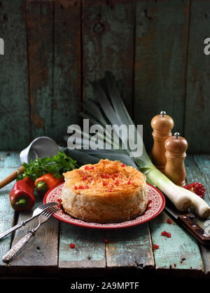 Chicken pie on a blue plate on a pink background Stock Photo - Alamy
