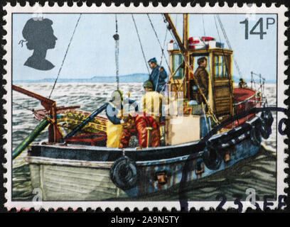 Fishing boat on british postage stamp Stock Photo - Alamy
