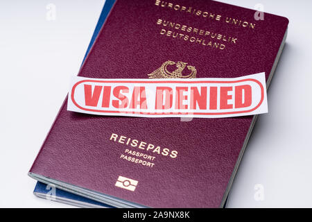 visa and passport with denied stamp on a document top view in ...
