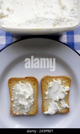 Staka Butter from Crete on Friganies Barley Rusks Stock Photo - Alamy