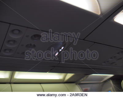 Overhead panel on a passenger jet aircraft with both the "fasten Stock ...