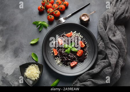 Squid Ink Pasta with , parmesan, basil leaves. Black spaghetti, black ...