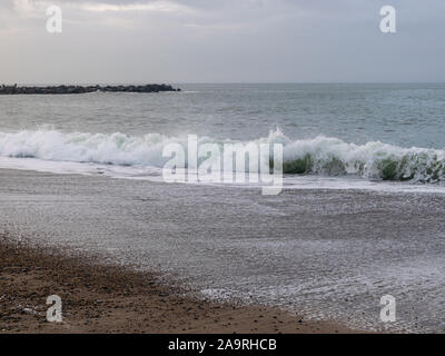 peaceful North Sea landscape with small waves and stone pier Stock ...
