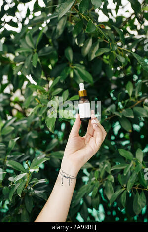 Young women bottle of oil against sunflowers - Image Stock Photo - Alamy