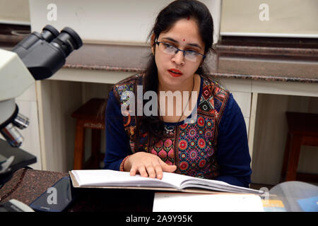 Female Student reading in Laboratory Stock Photo - Alamy