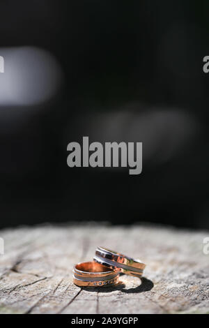 Macro close up of two wedding rings on wood Stock Photo - Alamy