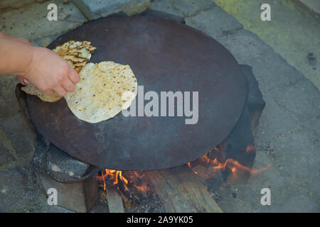 Outdoor Cooking preparing a flat bread Pita on a Saj Stock Photo - Alamy