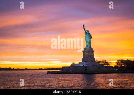 Amazing sunrise of Statue of Liberty over in new york orange sky Stock ...