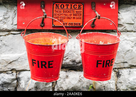 Red fire buckets filled with sand Stock Photo - Alamy