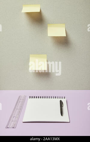 notebook near pen, ruler and sticky notes on grey and purple Stock ...