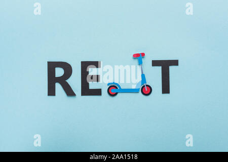 top view of paper cut kick scooter with location mark on blue ...