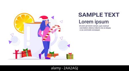 people near christmas drink mulled wine holding candy cane lollipop and ...