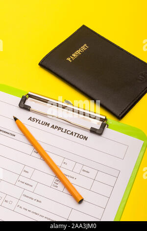 Asylum concept showing an application form for asylum on a yellow ...