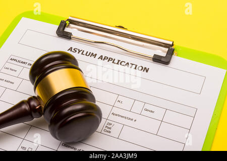 Asylum concept showing an application form for asylum on a yellow ...