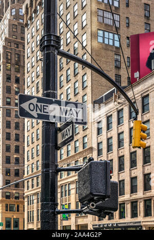 A one way sign and a traffic light in Ney York City, NYC Stock Photo ...