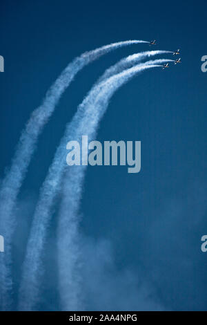 A picture of several airplanes in formation soaring through the sky ...