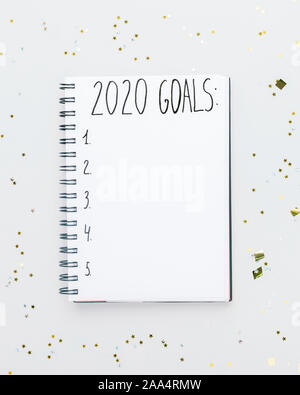 2020 goals list in notebook on background with gold confetti Stock ...