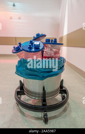 in a trash can in an operating theatre there are various suction ...