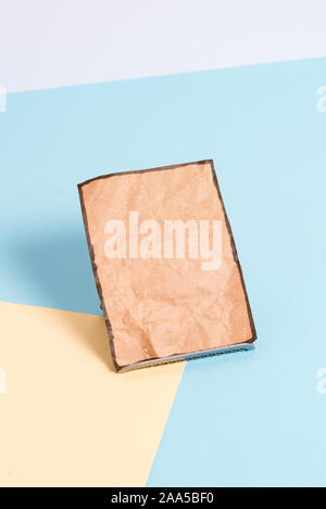 Paper placed tilted above buffer wire on soft pastel multi colours ...