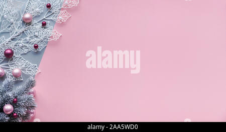 White winter twig with shiny geometric leaves and artificial Xmas tree ...