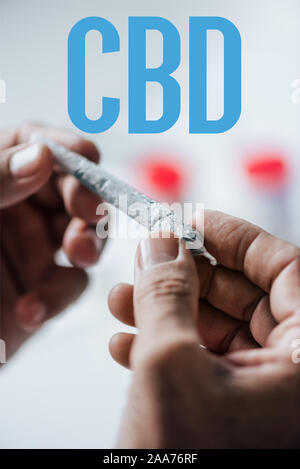 Man hands rolling blunt or joint with cannabis buds Stock Photo - Alamy