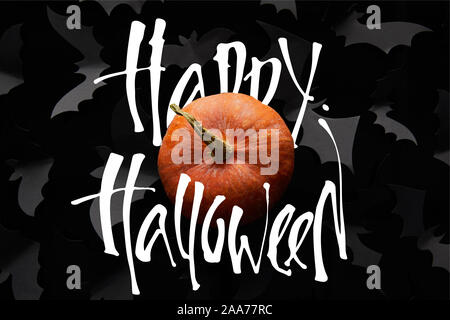 top view of paper black bats on white background with red happy ...