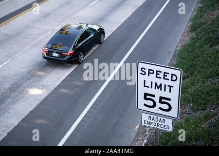 Speed limit 55 MPH. Speed enforced by radar. Warning road signs text in ...