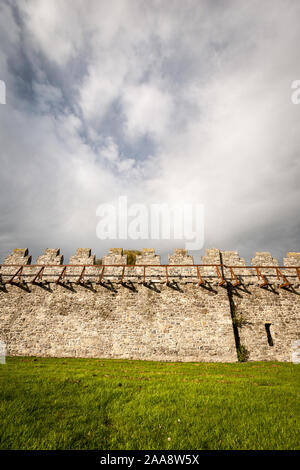 Stone building with battlements from low angle of view displaying ...