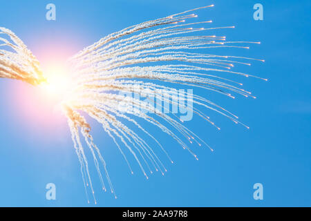 Explosion of a shell in the sky and burning debris flying with smoke ...