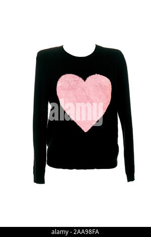 White woolen sweater with a red heart shaped pin on white background ...
