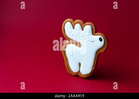 gingerbread cookie of little cute deer on red background. Traditional ...