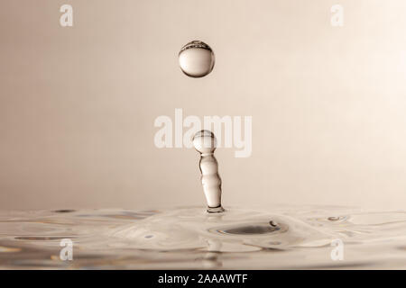 Water drops collision in sephia Stock Photo - Alamy