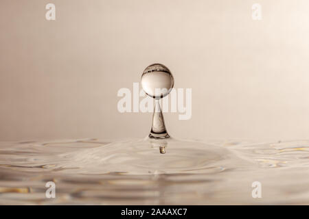 Water drops collision in sephia Stock Photo - Alamy