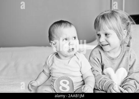 Two sad friends or sisters crying together on a couch in the living ...