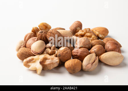 Different types of nuts, seeds and dried fruits on black background ...