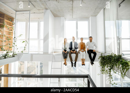 large group of employees sitting at office Desk Stock Photo - Alamy