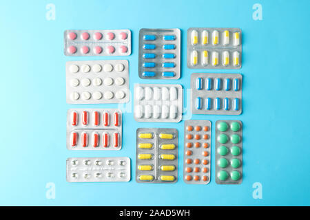 top view of blister packs with different pills on orange textured ...