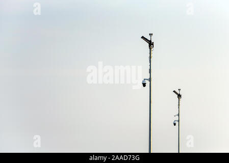Two CCTV cameras stand on a snow-covered roof against a sky. Security ...