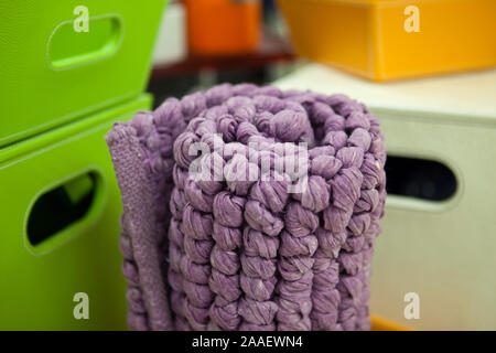 New rolled up bath mats on a store counter Stock Photo - Alamy