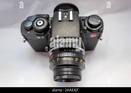 Close-up of Leica R7 film camera with 50mm prime lens on light wooden ...