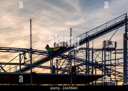 Roller coaster climbing hill Stock Photo - Alamy