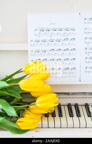 yellow tulips on a white piano Stock Photo - Alamy