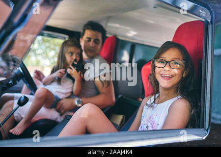 Close-up of siblings sitting in car Stock Photo - Alamy