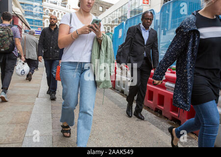 Pedestrians using mobile phones on the streets of London, UK Stock ...