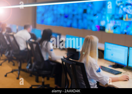 Female security guards working on computers while sitting in the main ...