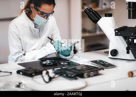 Forensic science investigator examining computer hard drive. Digital ...