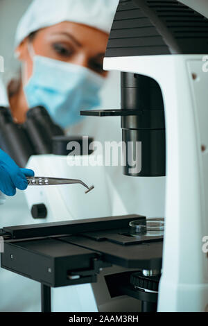 Scientist examining RFID implant chip in clean room Stock Photo - Alamy