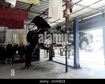 The mechanic is fixing the lower part of the car Pictures about the ...
