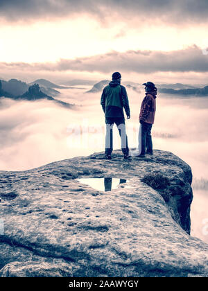 Happy romantic loving hikers couple at misty valley hugging and looking ...