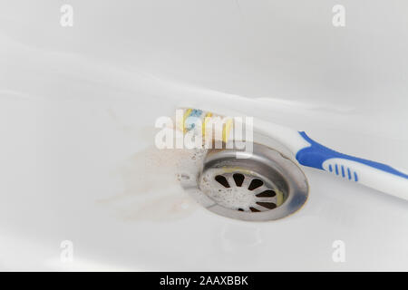 Blood and toothpaste on the toothbrush after cleaning and washing teath ...